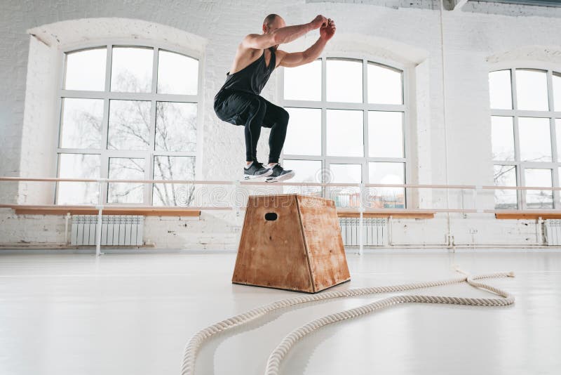 Side View of Strong Man Doing a Box Jump Exercise at Workout Gym Stock ...