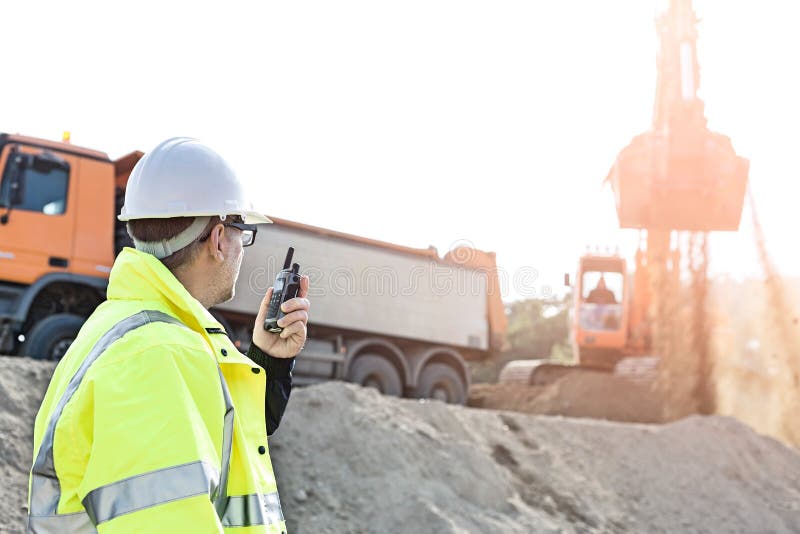 Side View of Supervisor Using Walkie-talkie at Construction Site ...