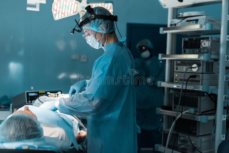 Side View of Surgeon Operating Patient Stock Image - Image of female ...