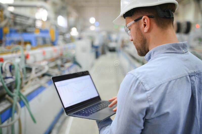 Side View of Technician or Engineer with Headset and Laptop Standing in ...