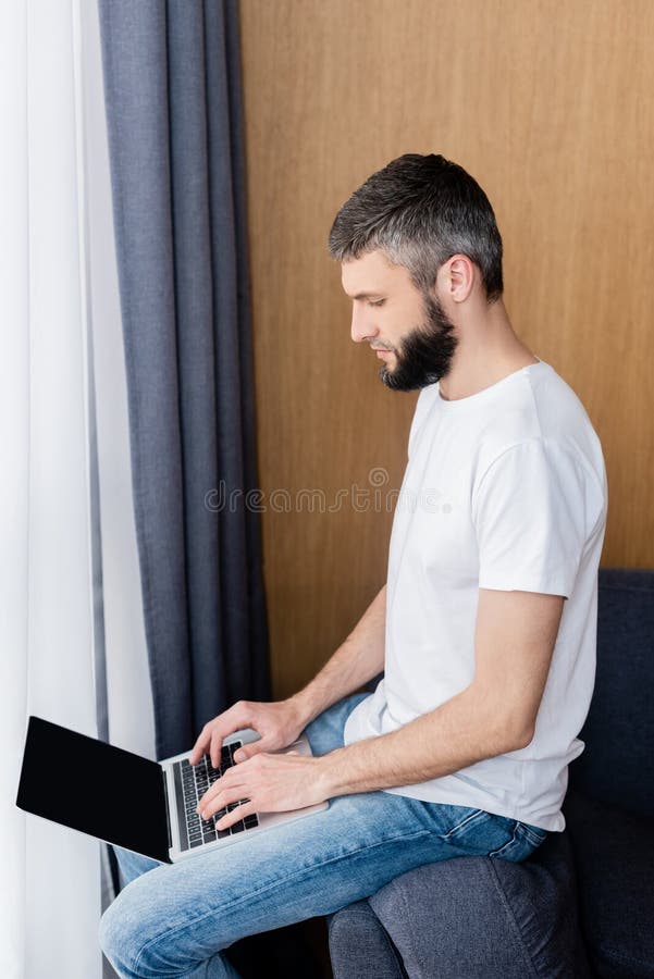 Side View of Teleworker Using Laptop on Sofa Stock Photo - Image of ...