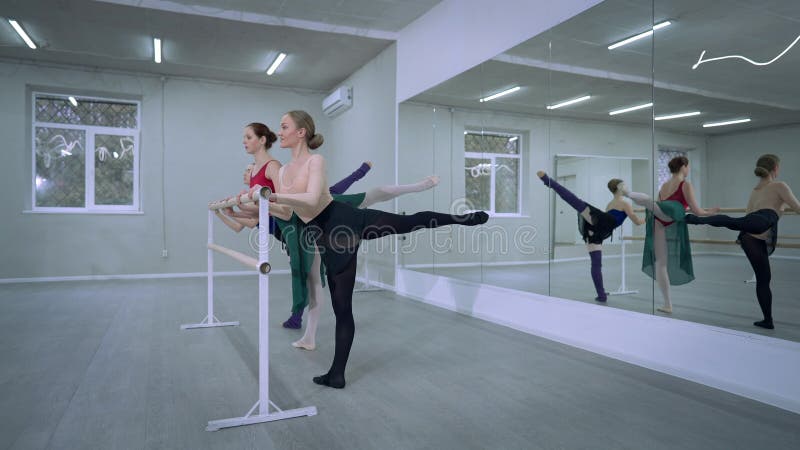 Side View Three Ballerinas Rehearsing Raising Leg Bending Forward ...