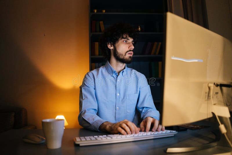 Side View of Tired Young Business Man Working on Computer in Dark Home ...