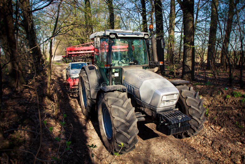 Side View of Tractor on Big Wheels on Soil Road in Forest Stock Image ...