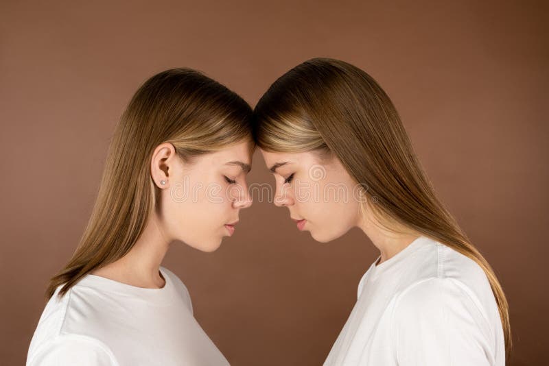 Side View of Twin Girls in White T-shirts Touching by Their Faces Stock ...