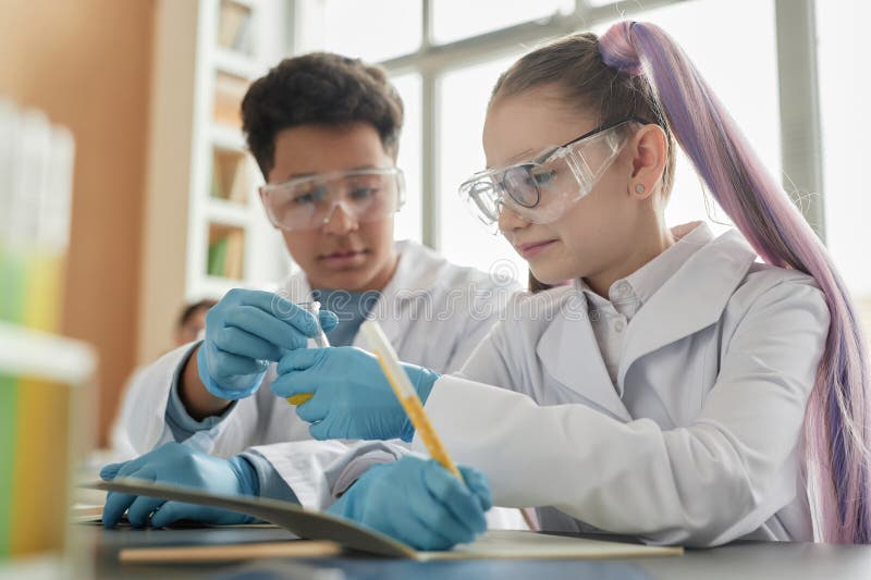 Side View Two Children Enjoying Experiments during Science Class in ...