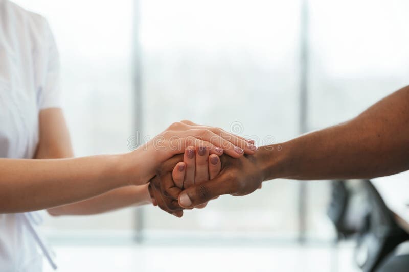 Side View. Two Doctors are Holding Hands Indoors Stock Photo - Image of ...