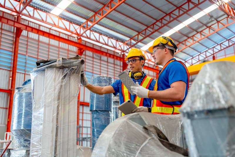 Side View of Two Factory Workers Hold Tablet Check and Maintenance the ...