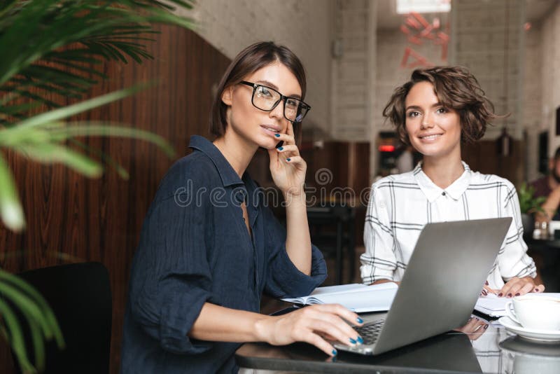 Side View of Two Female Managers Sitting by the Table Stock Image ...