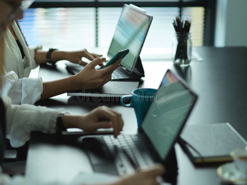 Two Female Workers Working with Digital Devices on Meeting Table Stock ...