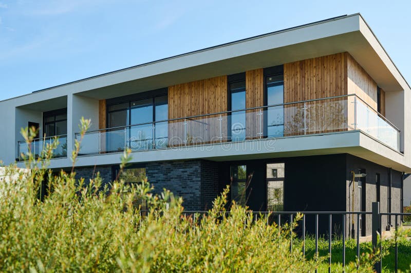 Side View of Two Storey Cottage with Windows and Balcony on Second ...