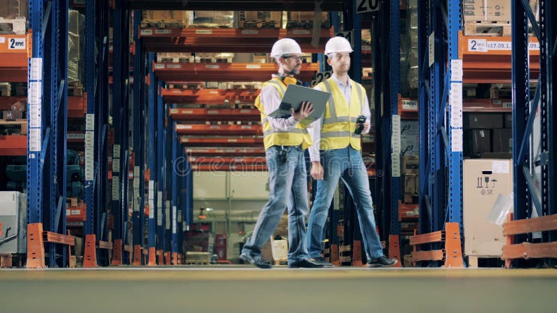 Two Warehouse Workers Inspecting a Package Together Stock Footage ...