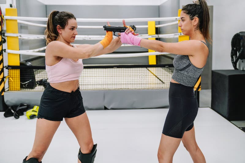 Two Women Practicing Self Defense with a Gun Stock Photo - Image of ...