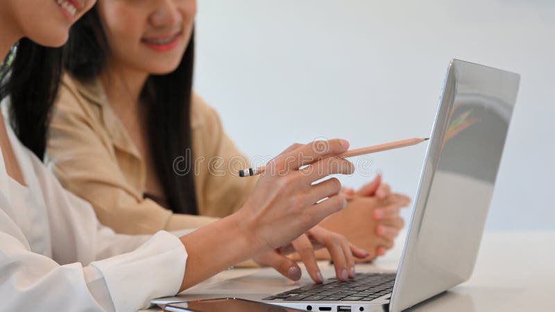 Side View of Two Young Pretty Female Students Doing Assignment with ...