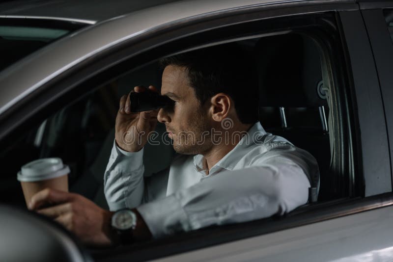 Side View of Undercover Male Agent Doing Surveillance by Binoculars and ...