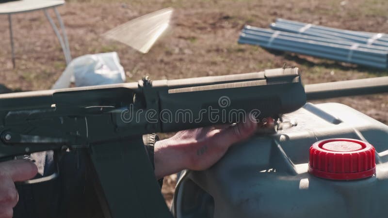 Side View of Unrecognizable Shooter Shooting into Target. Gun ...