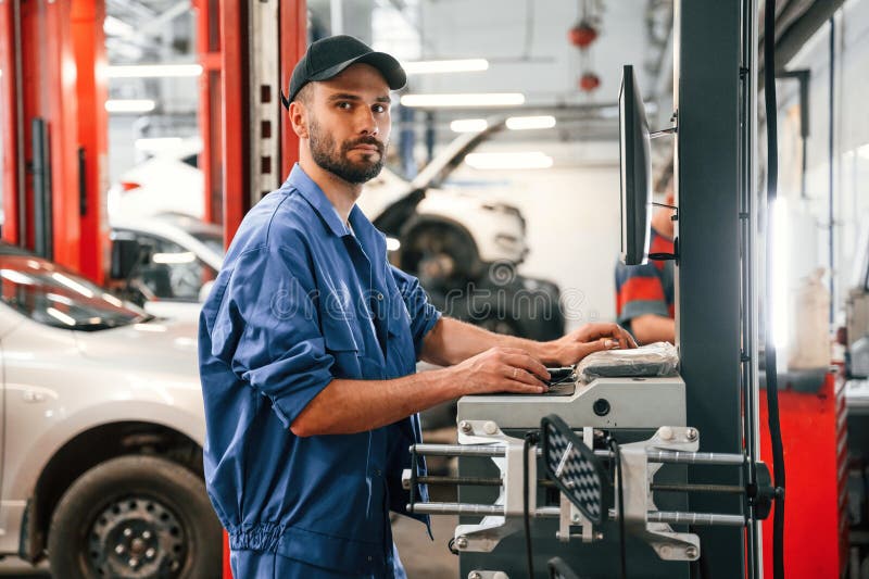 Side View, Using Computer. Auto Mechanic Working in Garage Stock Image ...