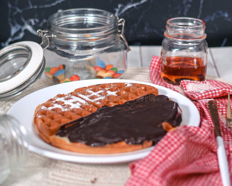 Side View of a Waffle Smeared in a Chocolate Syrup with Sweets on a ...
