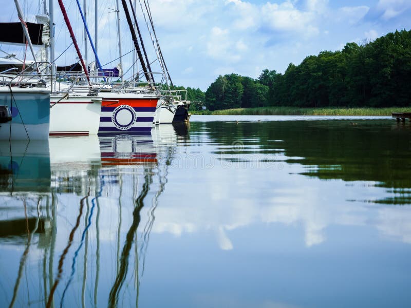 Side View from Water on Moored Sailboats with Reflection in the Lake ...