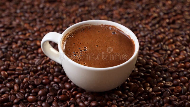 Side View of White Cup of Black Coffe on Coffee Beans Stock Footage ...