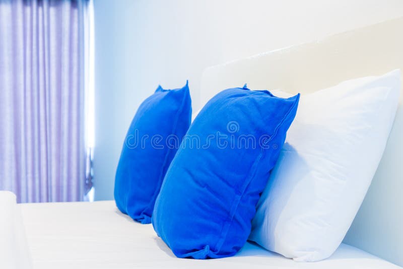 Side View of White Pillows and Blue Cushions on Bed in Bedroom Stock ...