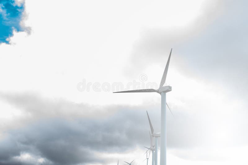 Side View of Wind Turbines between Clouds Stock Photo - Image of ...