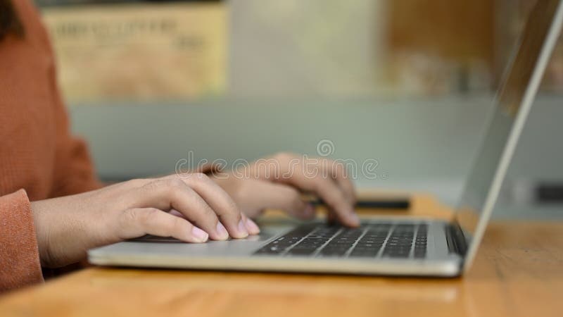 Side View of Woman Hands Typing on Laptop while Working Remotely in ...