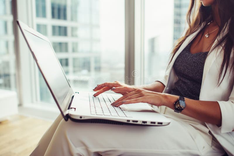 Side View of Woman Holding Laptop on Her Lap Working in Office Stock ...