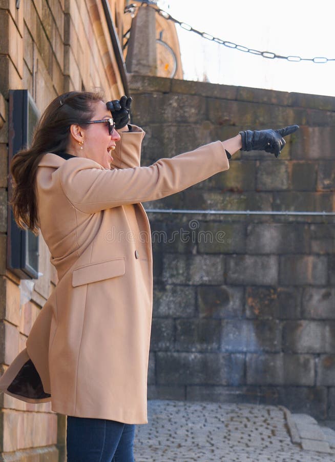 Side View of Woman Pointing and Smiling Stock Image - Image of looking ...