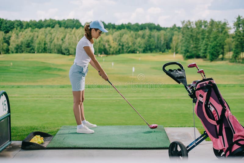 Side View of Woman in Polo and Cap Playing Golf Stock Photo - Image of ...