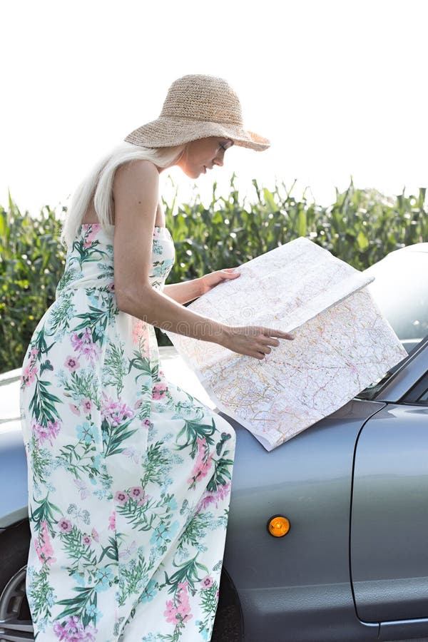 Side View of Woman Reading Map while Sitting on Convertible Stock Image ...