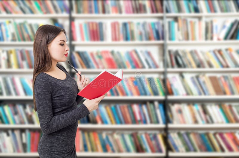 Side View of a Woman with Red Book in Library Stock Image - Image of ...