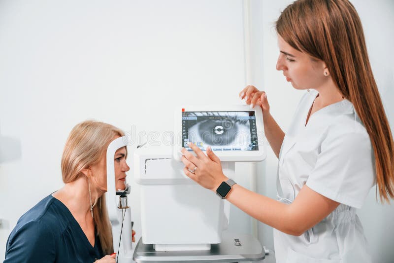 Side View. Woman`s Vision is Tested by Clinic Worker that Using Special ...