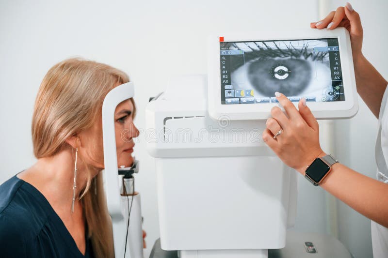 Side View. Woman`s Vision is Tested by Clinic Worker that Using Special ...