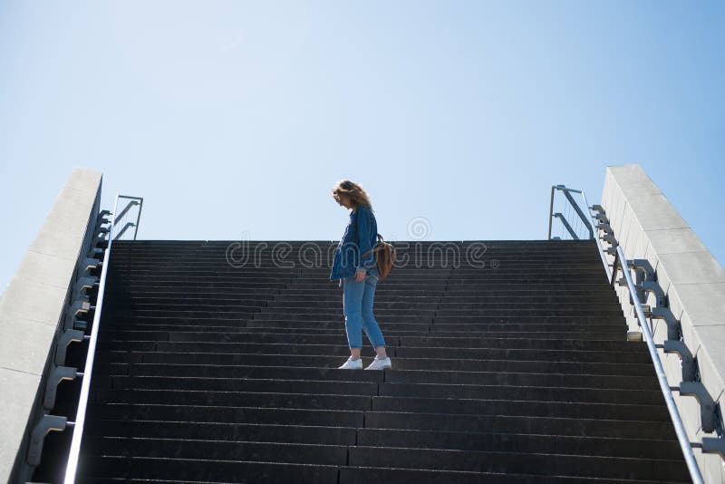 Side View of Woman Standing on Steps with Blue Sky on Background Stock ...