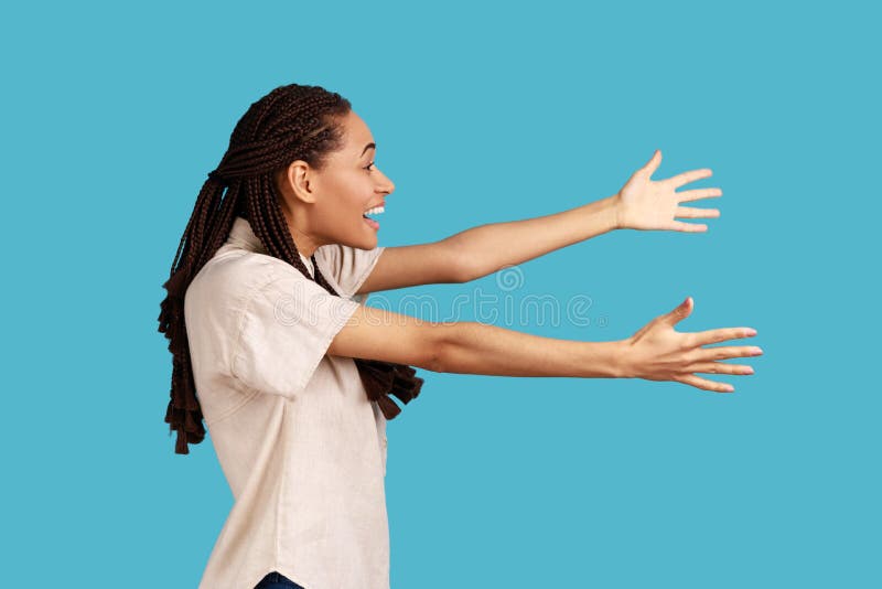 Side View Of Woman Stretches Hands And Looks Directly At Camera Gives