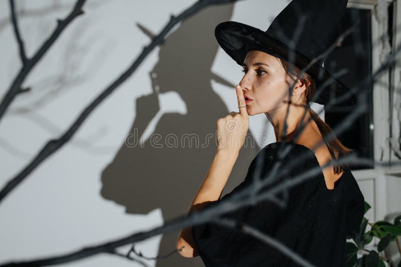 Side View of a Woman in a Witch Costume, Making a Shush Gesture ...