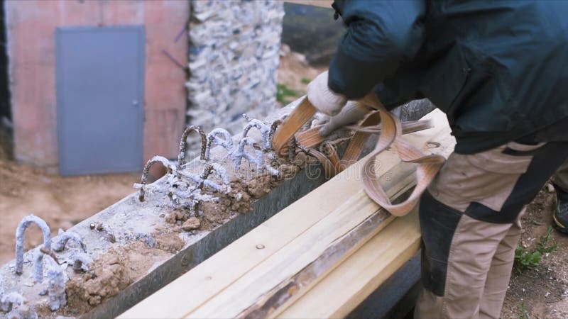Side View of a Worker Putting the Construction Rope Out of the Concrete ...