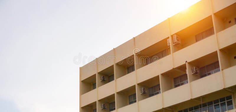 Side View of Yellow Concrete Building Intersect the Orange Sun Stock ...