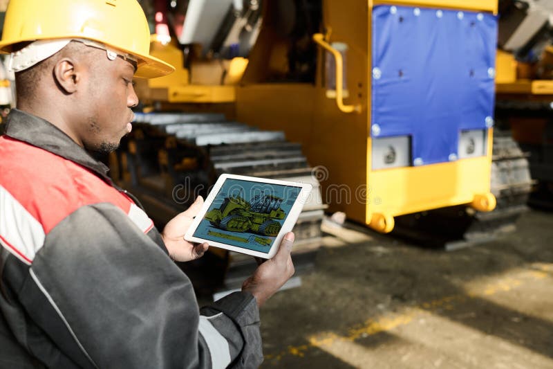 Side View of Young African American Engineer Looking at Machine Picture ...