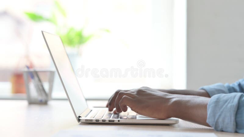 Side View of Young African Man Typing on Laptop Keyboard Stock Image ... Side View of Young African Man Typing on Laptop Keyboard Stock Image ...