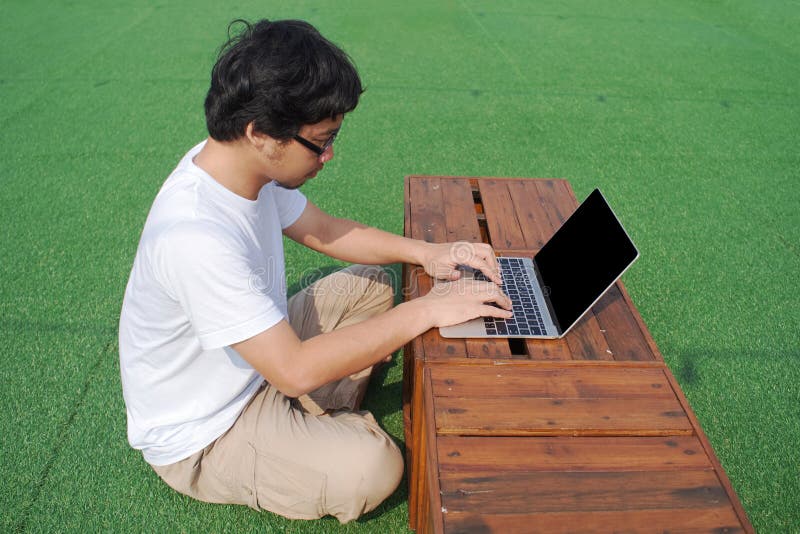 Side View of Young Asian Man Using Computer Laptop at Outdoors. Stock ...
