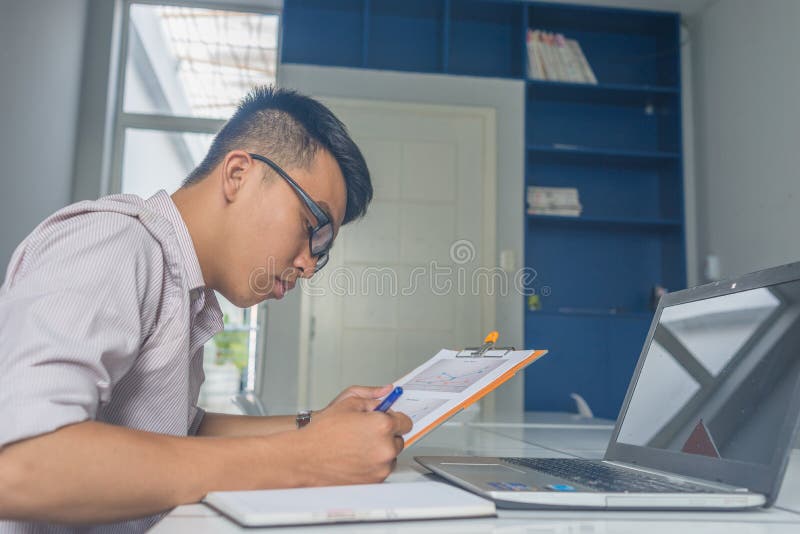 Side View of Young Asian Man Writing Note into the Notebook Stock Image ...