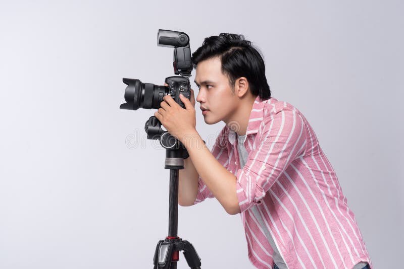 Side View of Young Asian Photographer Holding Digital Camera, while ...