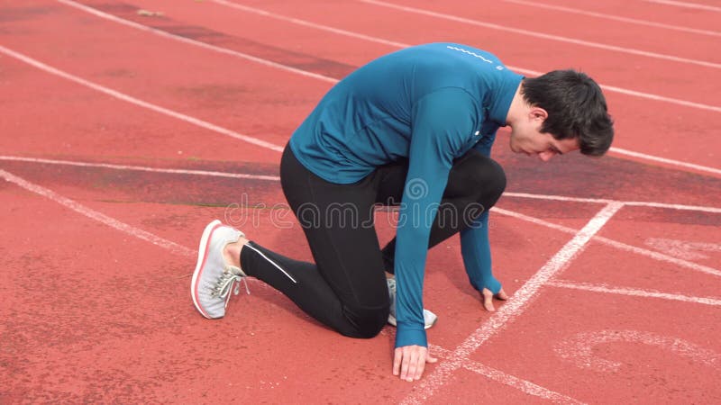 An Athlete Getting Ready for a Sprint on the Athletic Track To Compete ...
