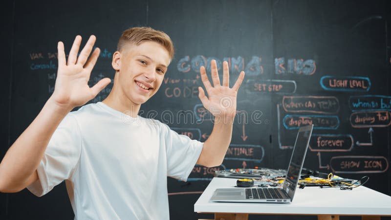 Side View of Young Boy Programing Code while Looking at Camera ...