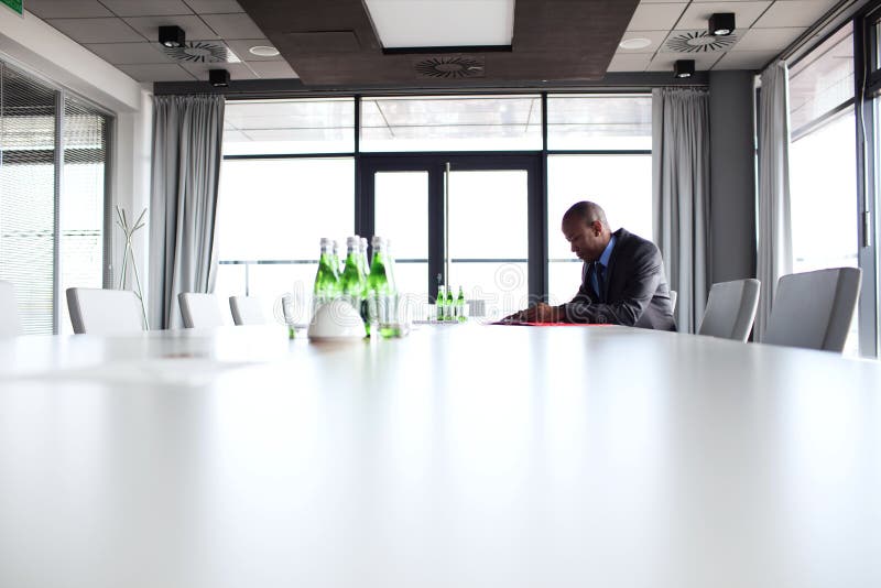 Side View of Young Businessman Sitting at Conference Table Stock Image ...
