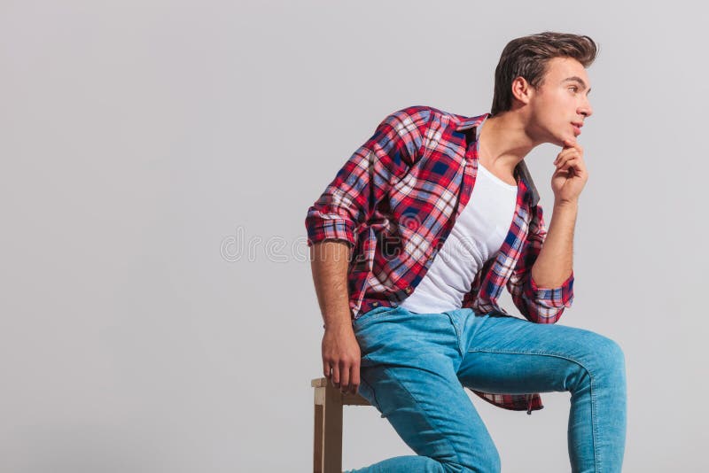 Side View of a Young Casual Man Thinking while Sitting Stock Photo ...