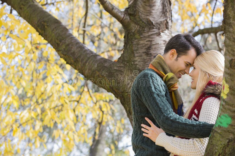 Young Couple Enjoying Falling Autumn Leaves in Park Stock Photo - Image ...
