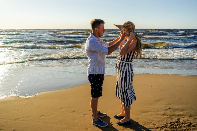 Side View of Young Couple in Love on Sandy Beach Stock Image - Image of ...